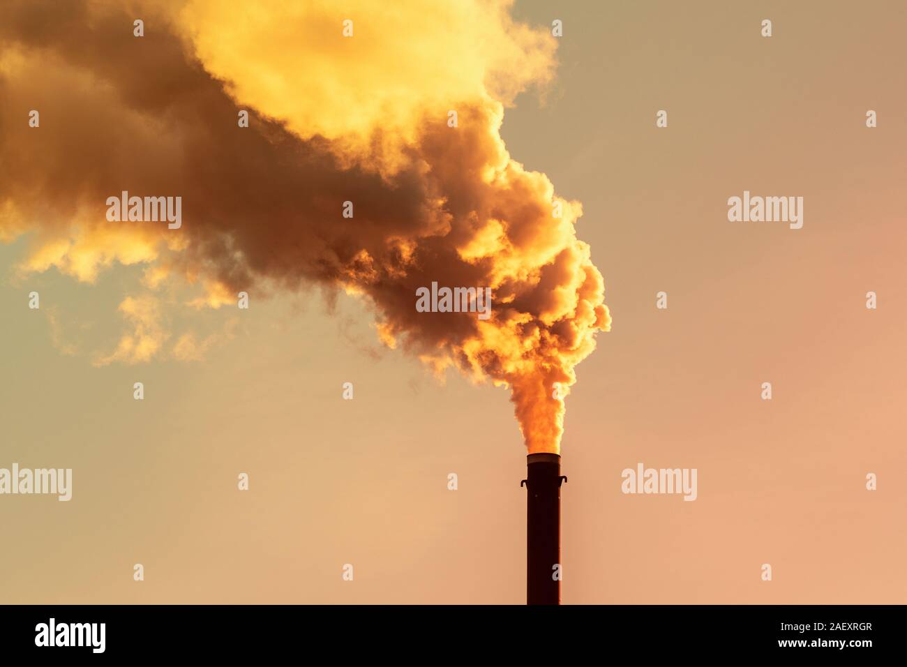 Smoking chimney of a factory at sunset.Pollution poor air quality ...