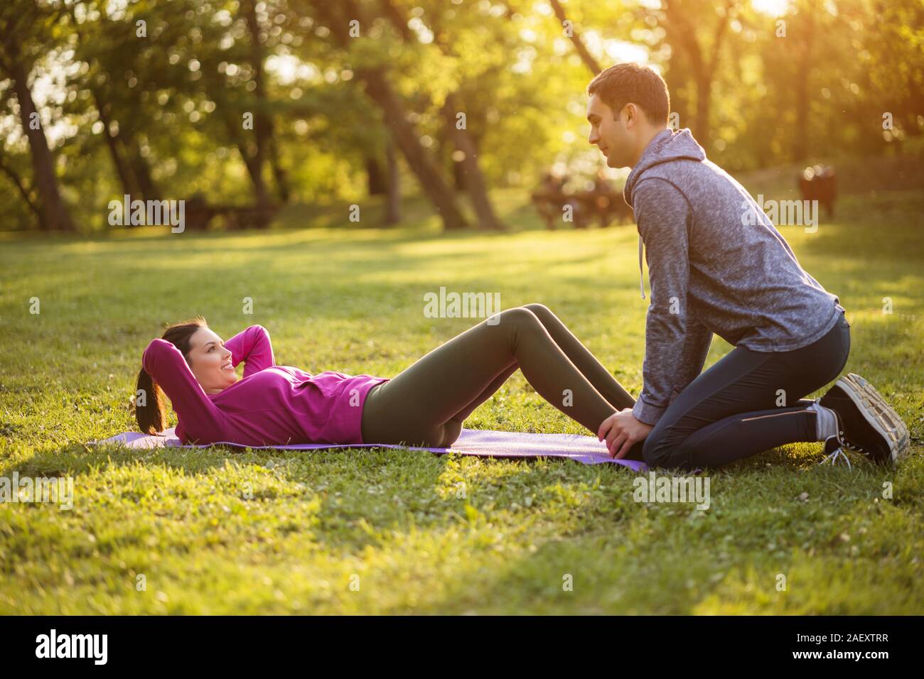 Physical therapist is showing exercises for sciatica recovery to young ...