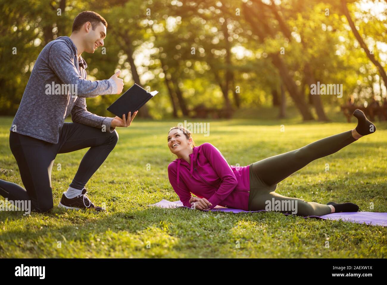 Physical therapist is showing exercises for sciatica recovery to young ...