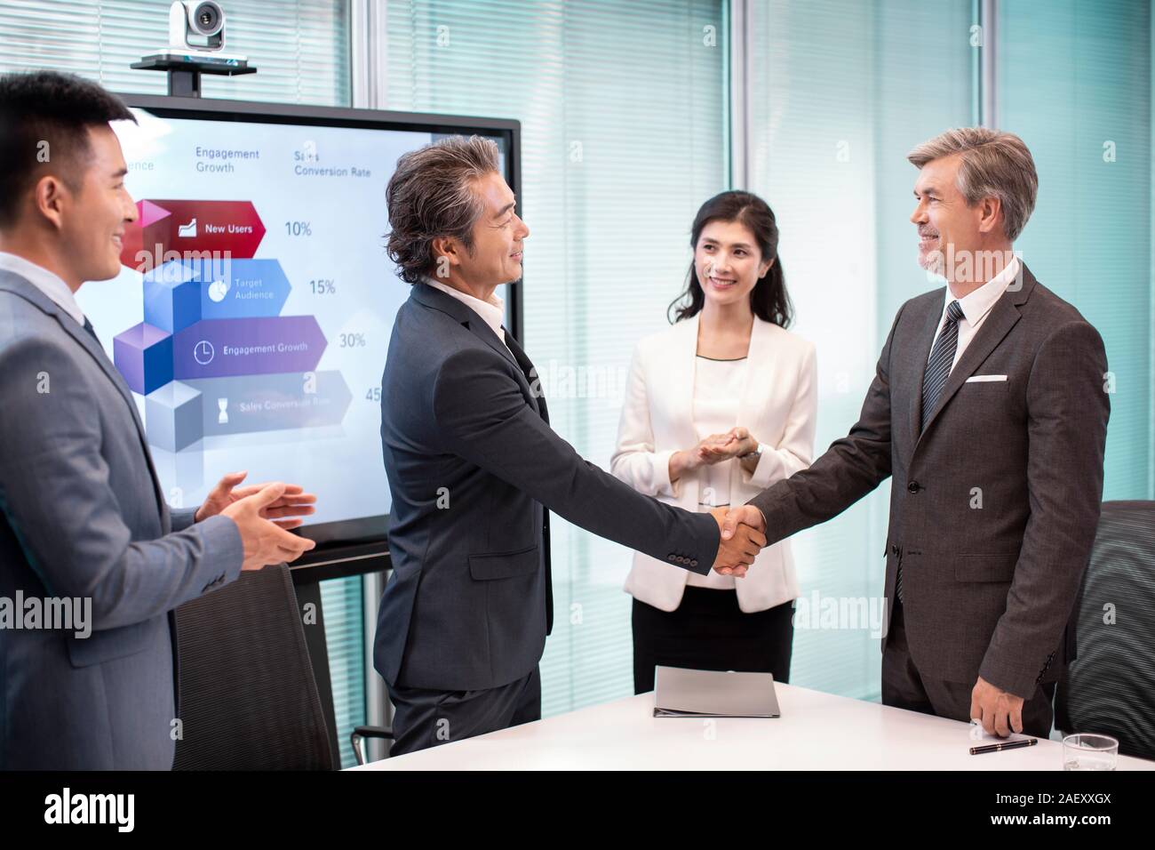 Business people shaking hands in conference room Stock Photo - Alamy