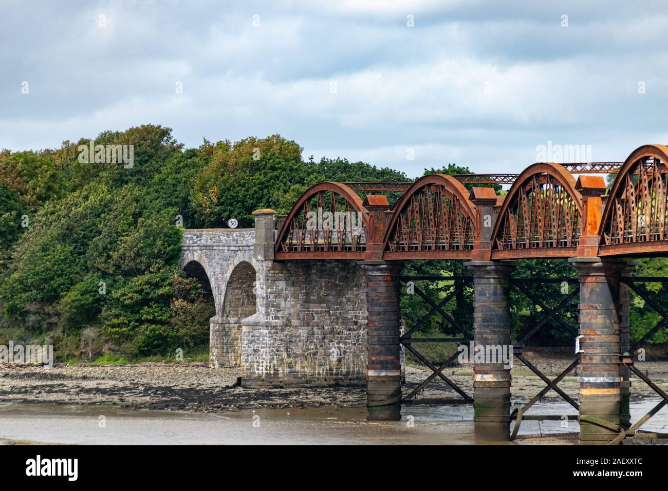Mud flats underneath the railway bridge crossing the River Tavy at low ...