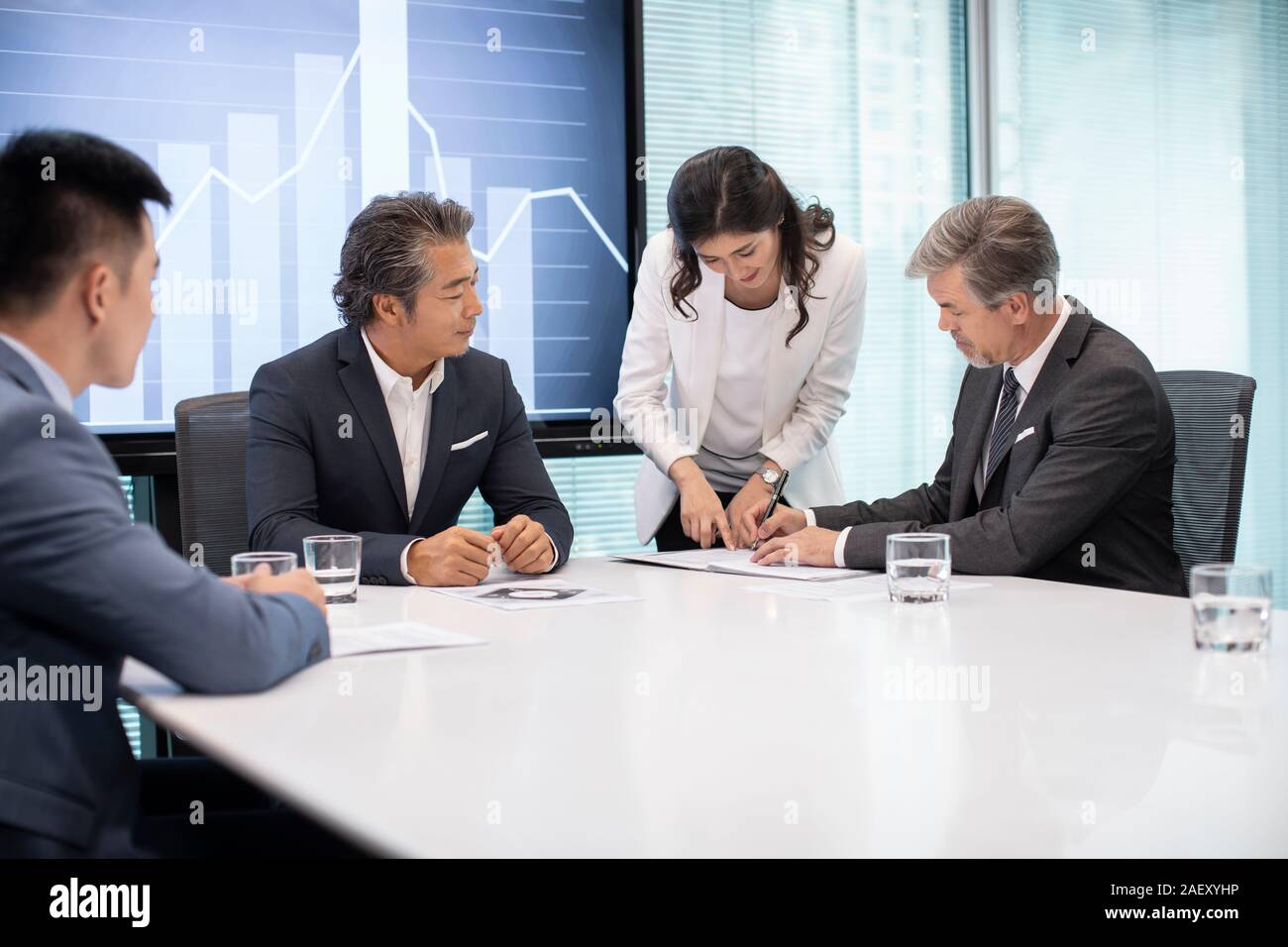 Business people signing contract in conference room Stock Photo - Alamy