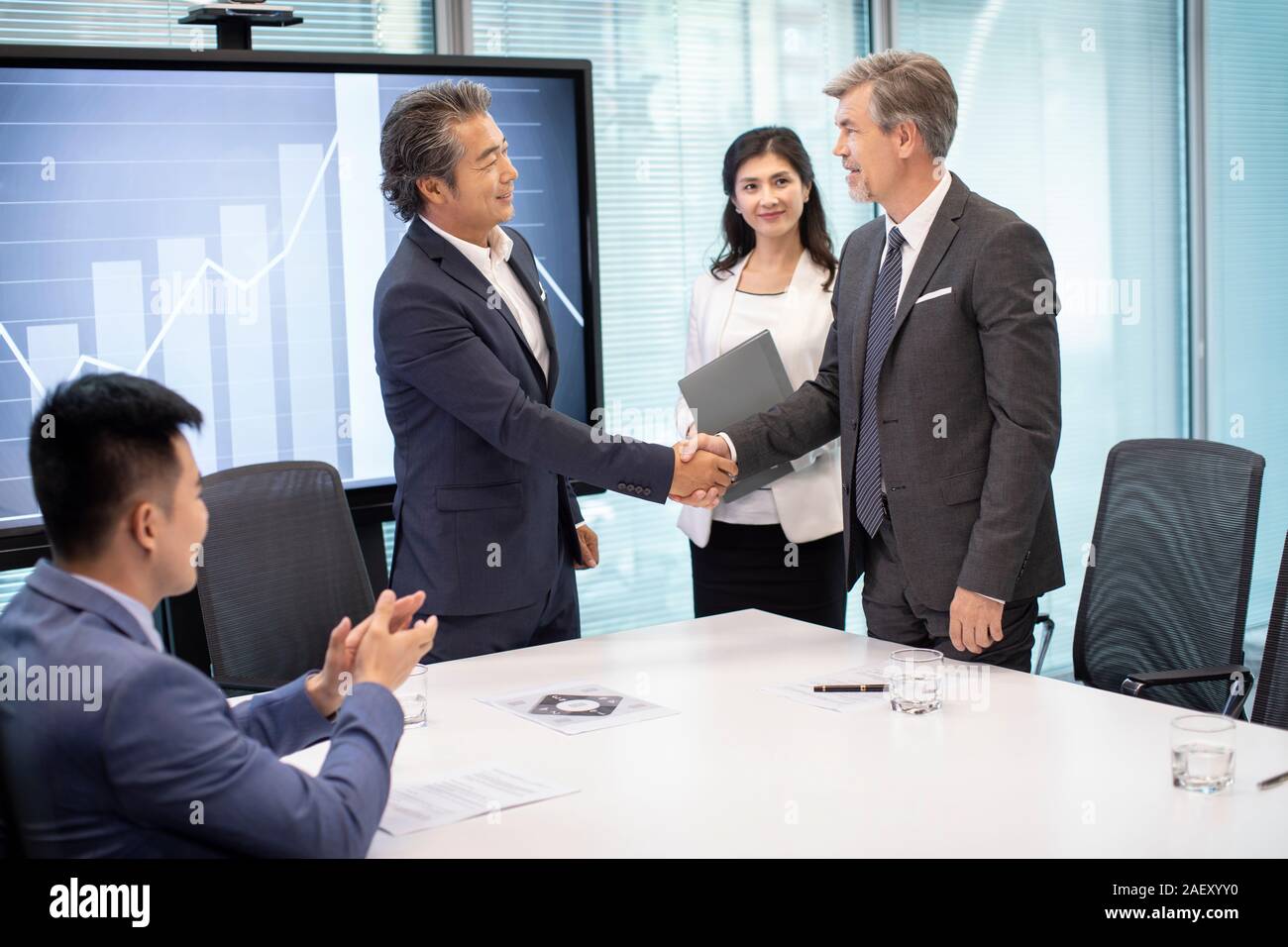 Business people shaking hands in conference room Stock Photo - Alamy