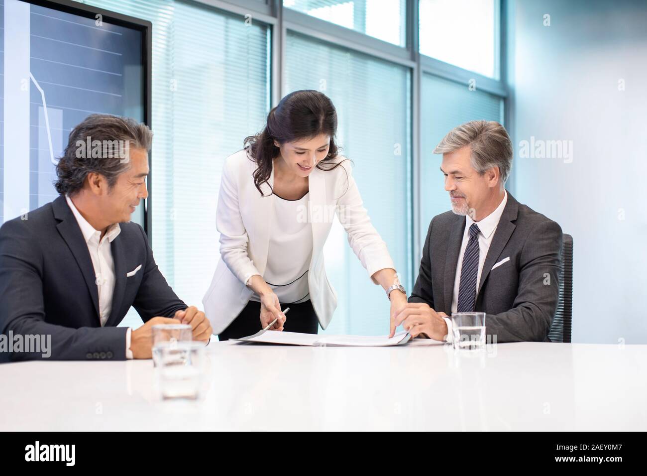 Business people signing contract in conference room Stock Photo - Alamy