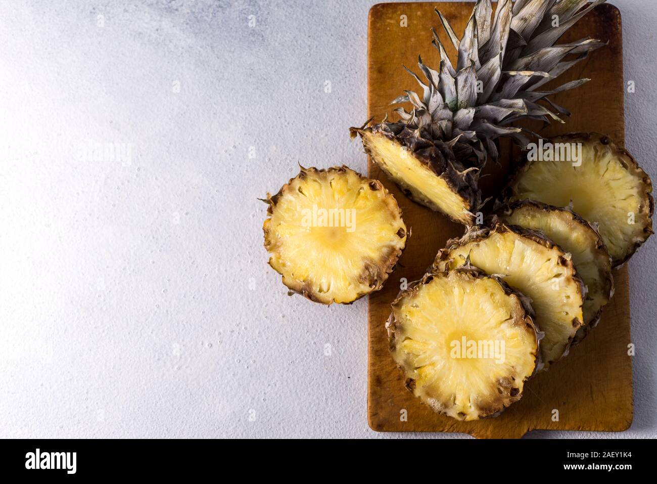 Pineapple on wood texture background. Whole and sliced tropical ...