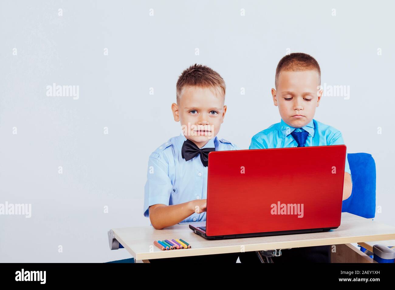 study on the computer two boys at school Stock Photo - Alamy