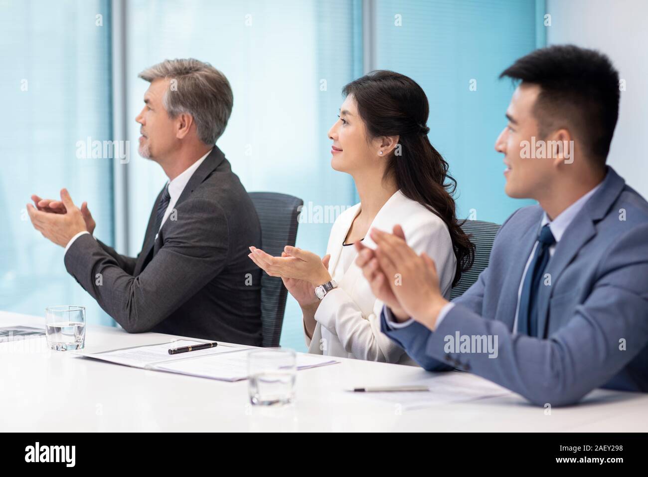 Business people clapping hands in conference room Stock Photo - Alamy
