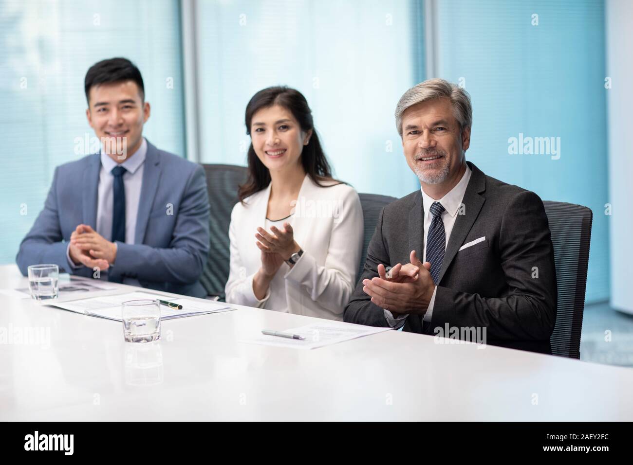 Business people clapping hands in conference room Stock Photo - Alamy