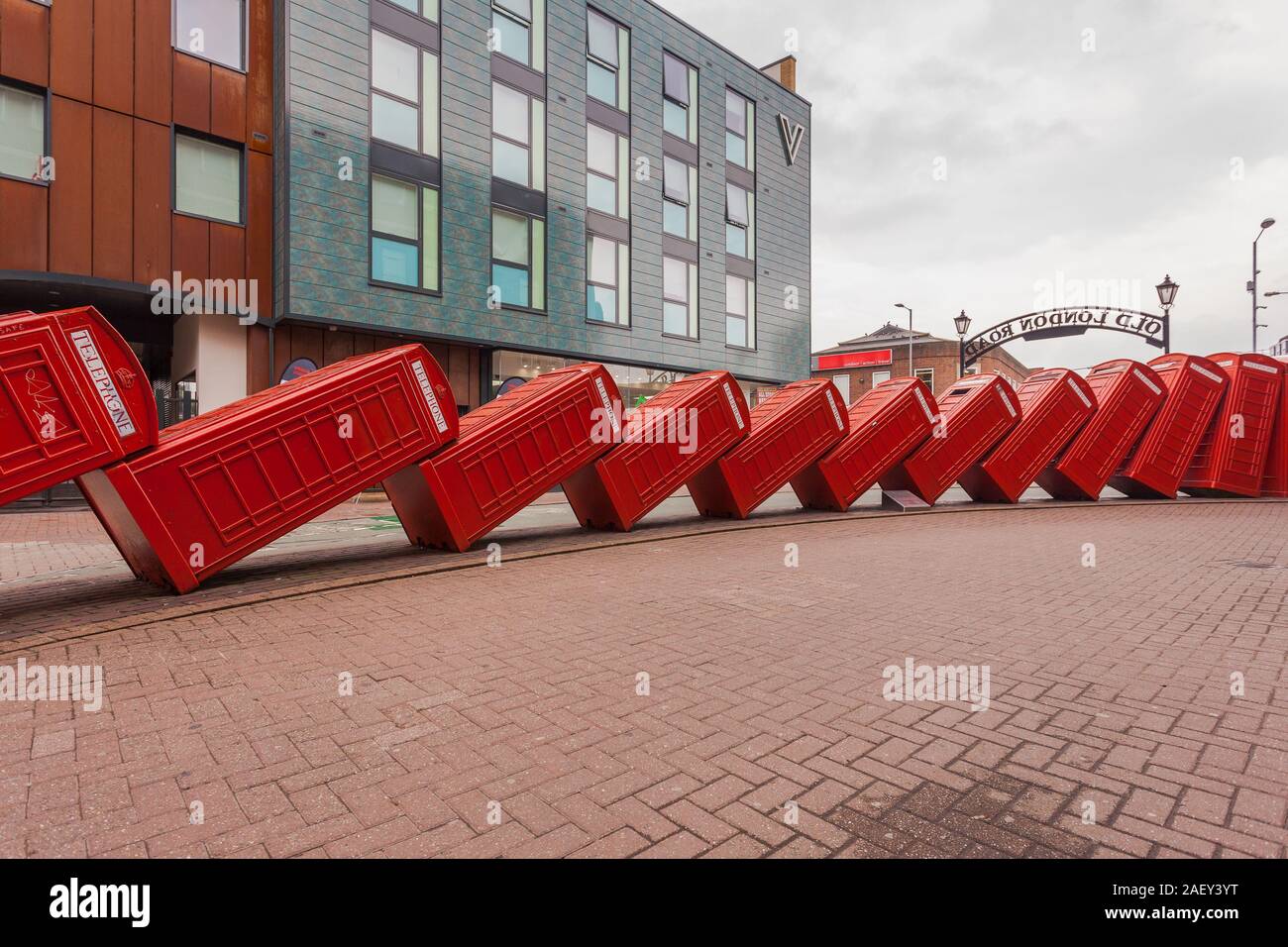 A row of slanting iconic telephone booths in London Stock Photo - Alamy