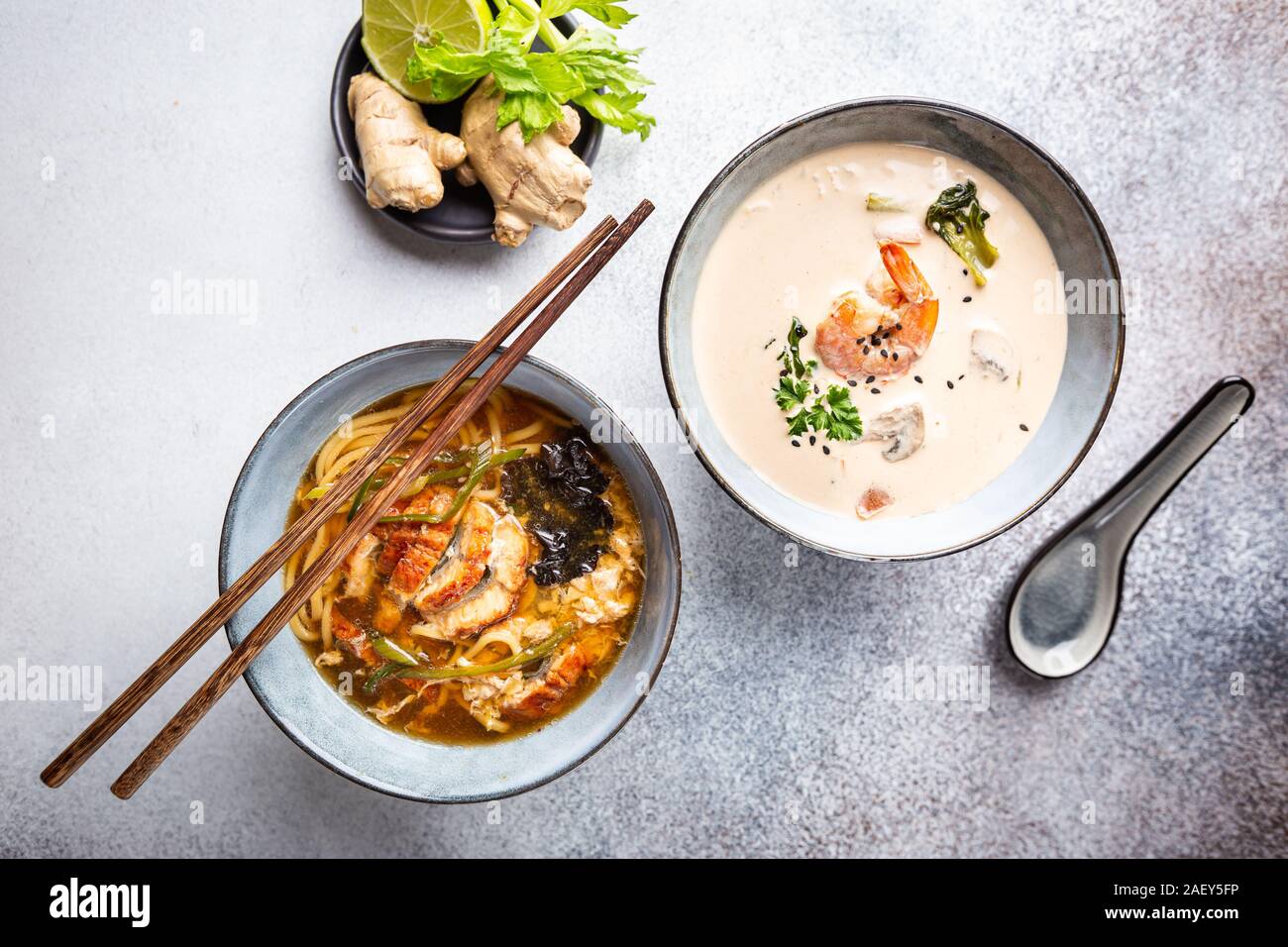 Set of Serving Asian Soups on gray background top view. Tom Yum Soup ...