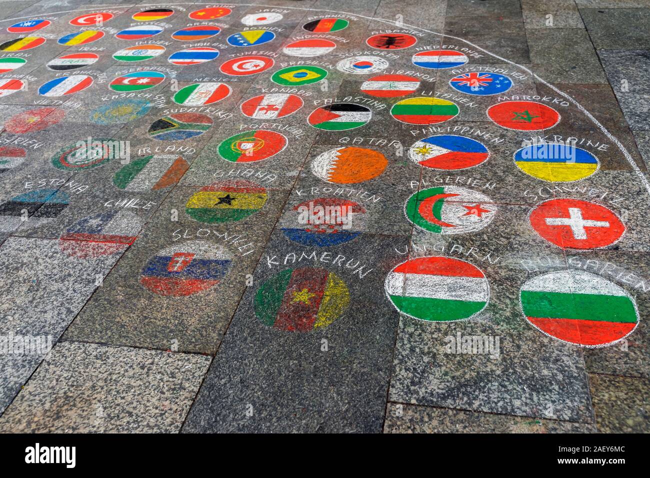 Emblems, flags of different countries painted on the pavement with ...
