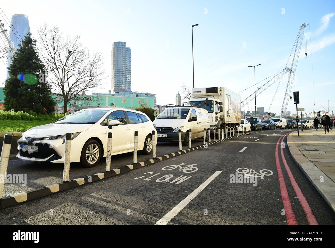 Cars queue next to an empty cycle lane in London Stock Photo - Alamy