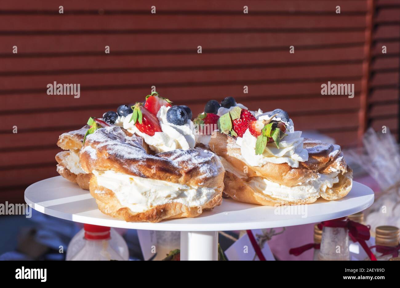 Confectionery stand offering sweet cream puffs, embellished with ...