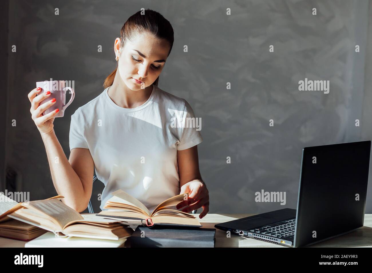girl reading a book and drinking coffee Stock Photo - Alamy