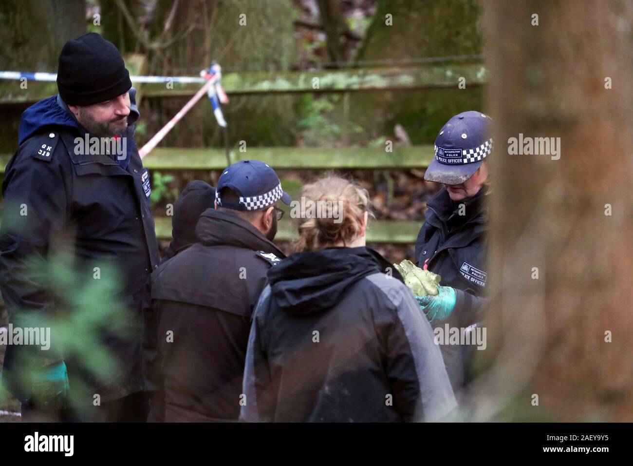 Police forensics teams search ditches and woodland at a site near ...