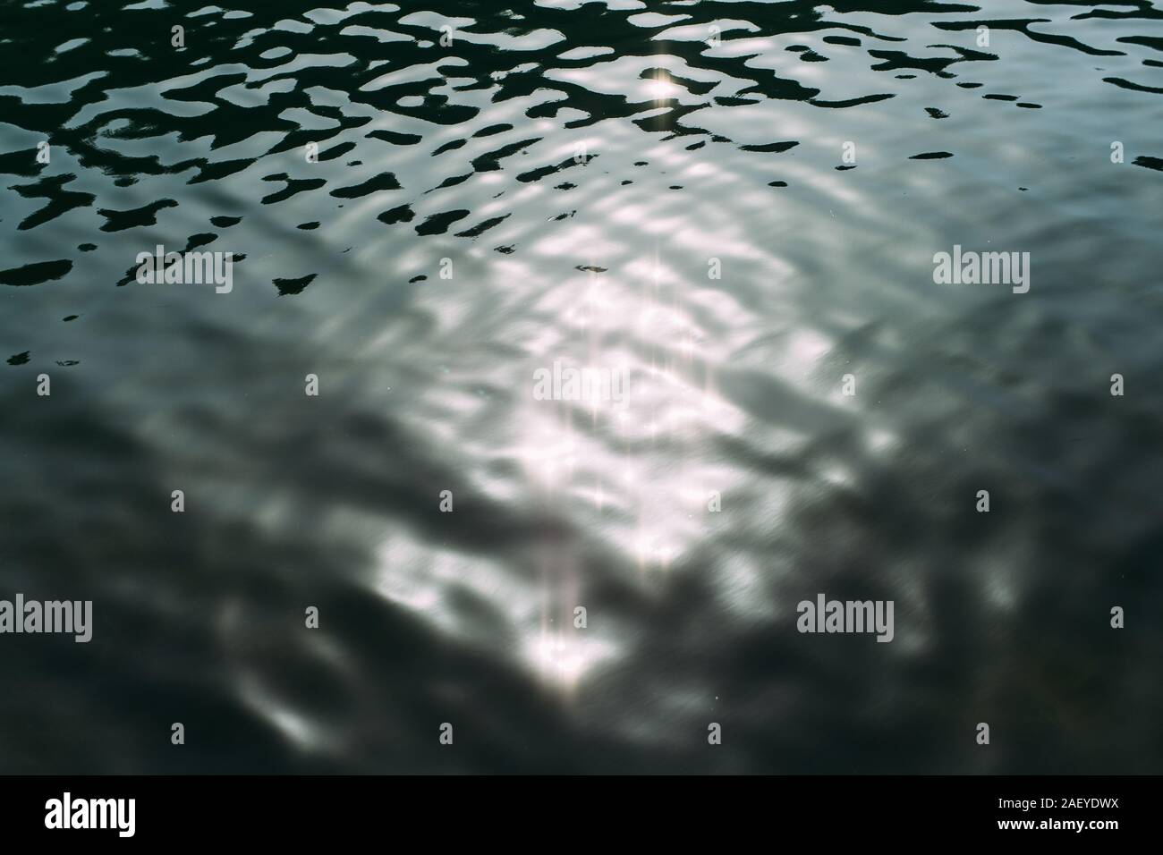 Patch of reflected light on the water Stock Photo - Alamy