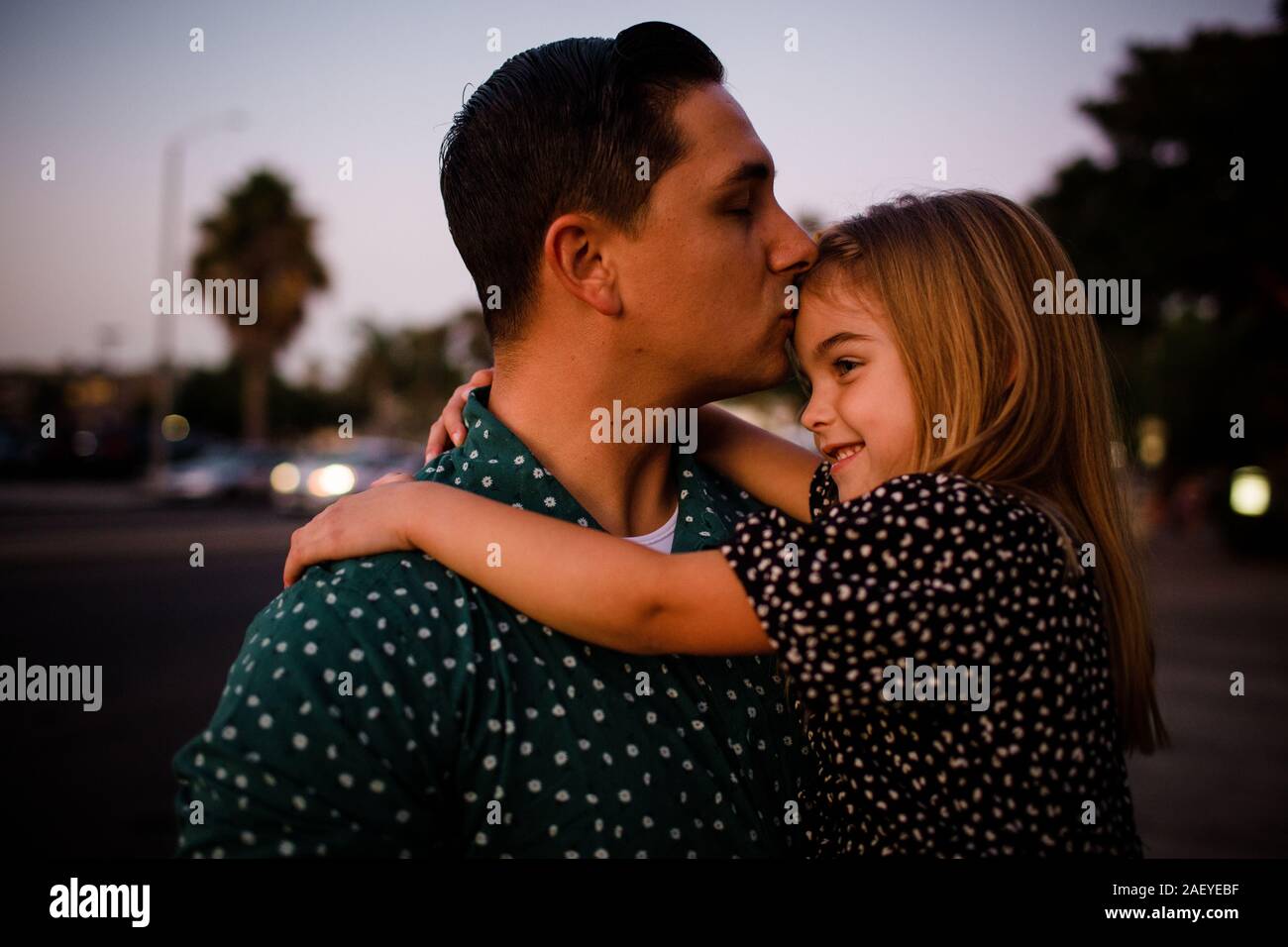 Father Kissing Daughter on Forehead Stock Photo - Alamy