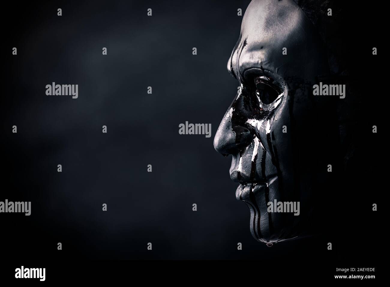 Scary figure with creepy bloody mask in the dark Stock Photo - Alamy