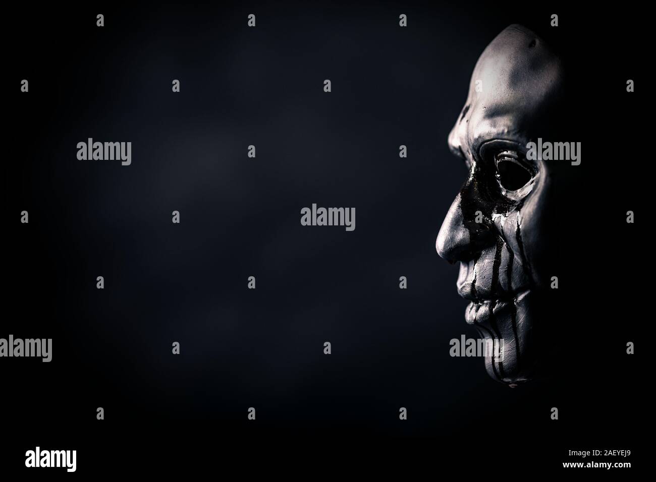 Scary figure with creepy bloody mask in the dark Stock Photo - Alamy