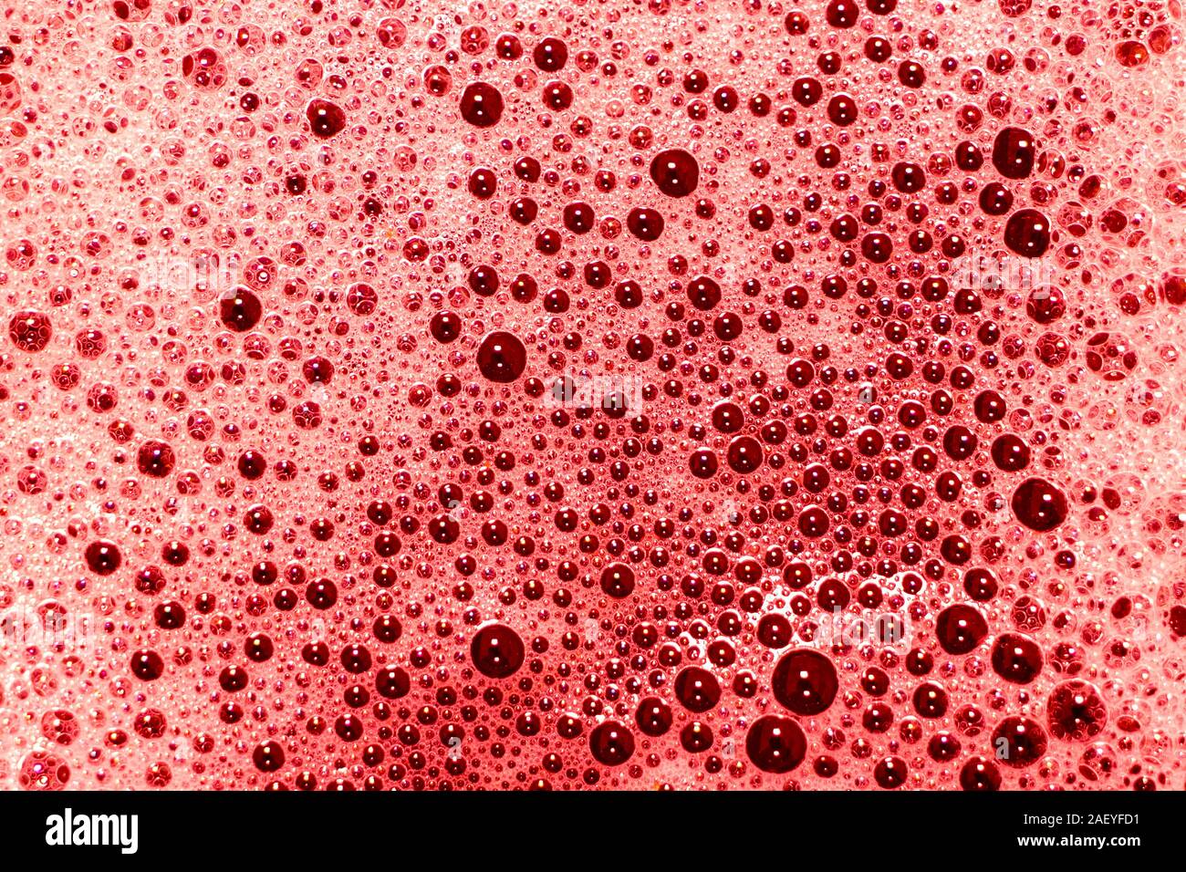 Abstract background and texture of red bubbles with light illumination ...