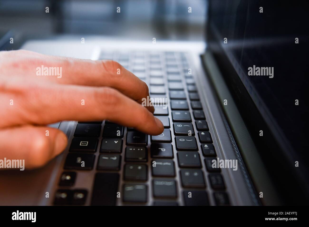 In this photo illustration a hand seen operating a keyboard Stock Photo ...