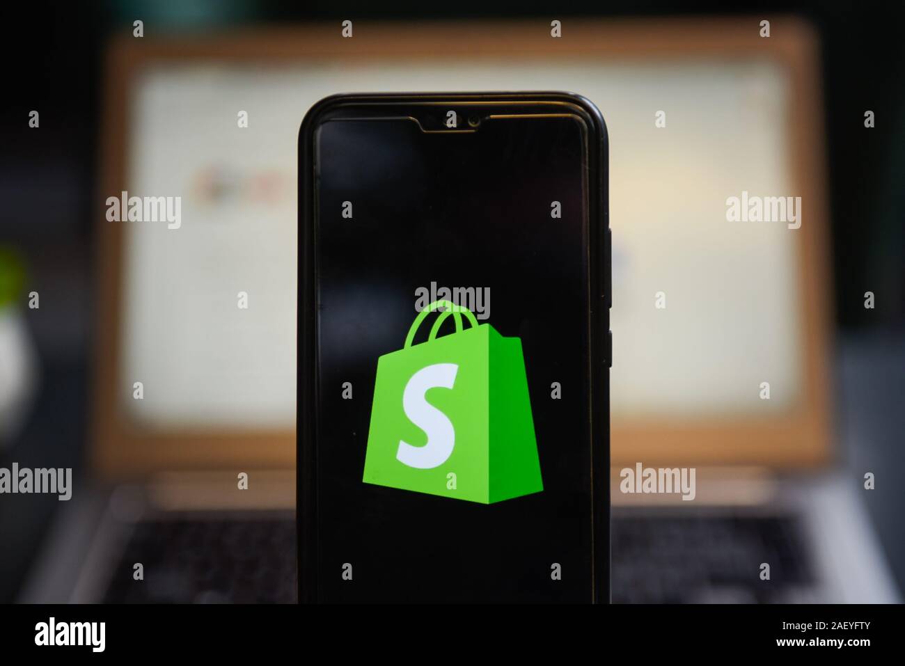 In this photo illustration a Shopify logo seen displayed on a ...