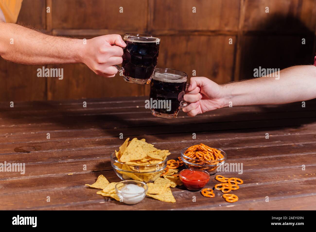 Hands of two men holding beer glasses drinking beer together Stock ...