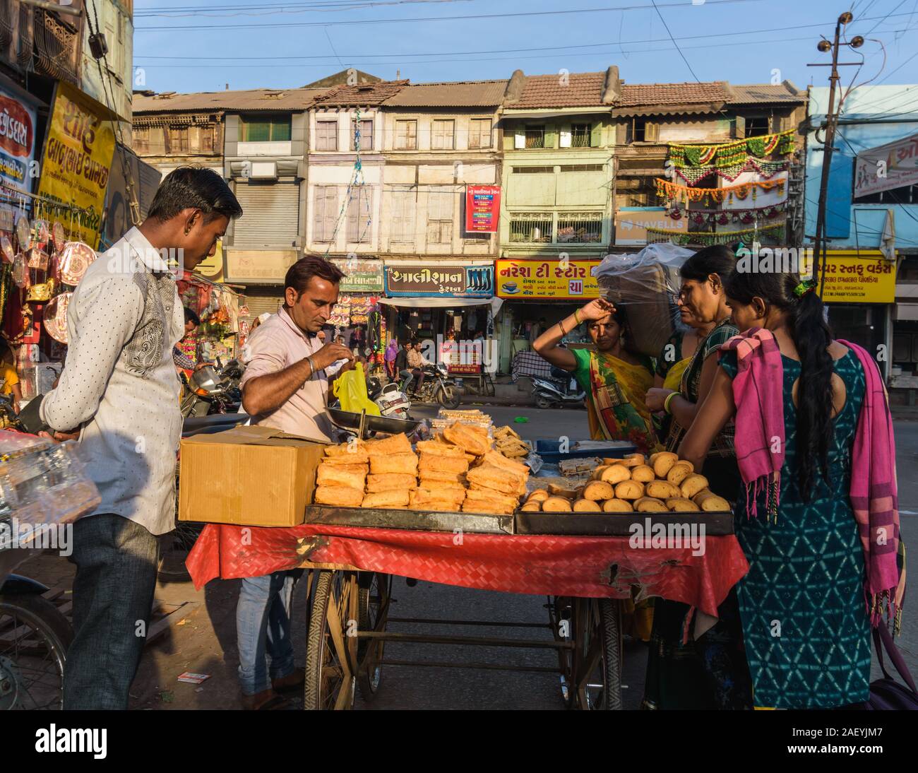 A colorful market scene from the old town with a street vendor selling ...