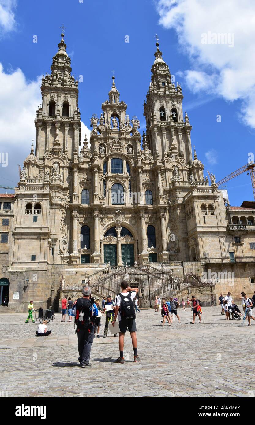 Pilgrims with scallop shell, symbol of Camino de Santiago, in front of ...