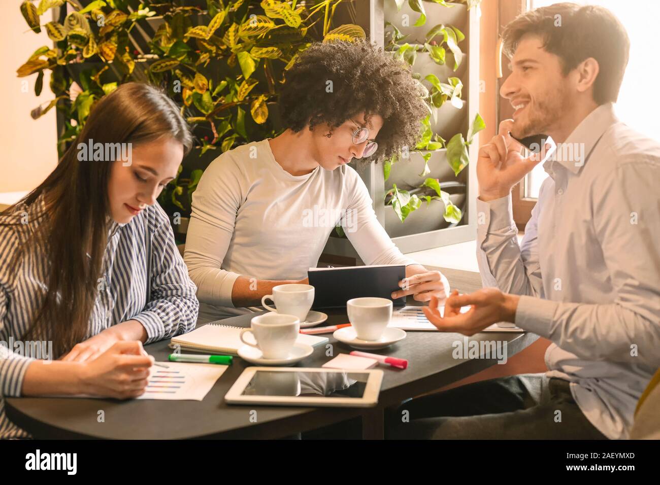Boss and employees gap. Team leader talking on phone while other ...