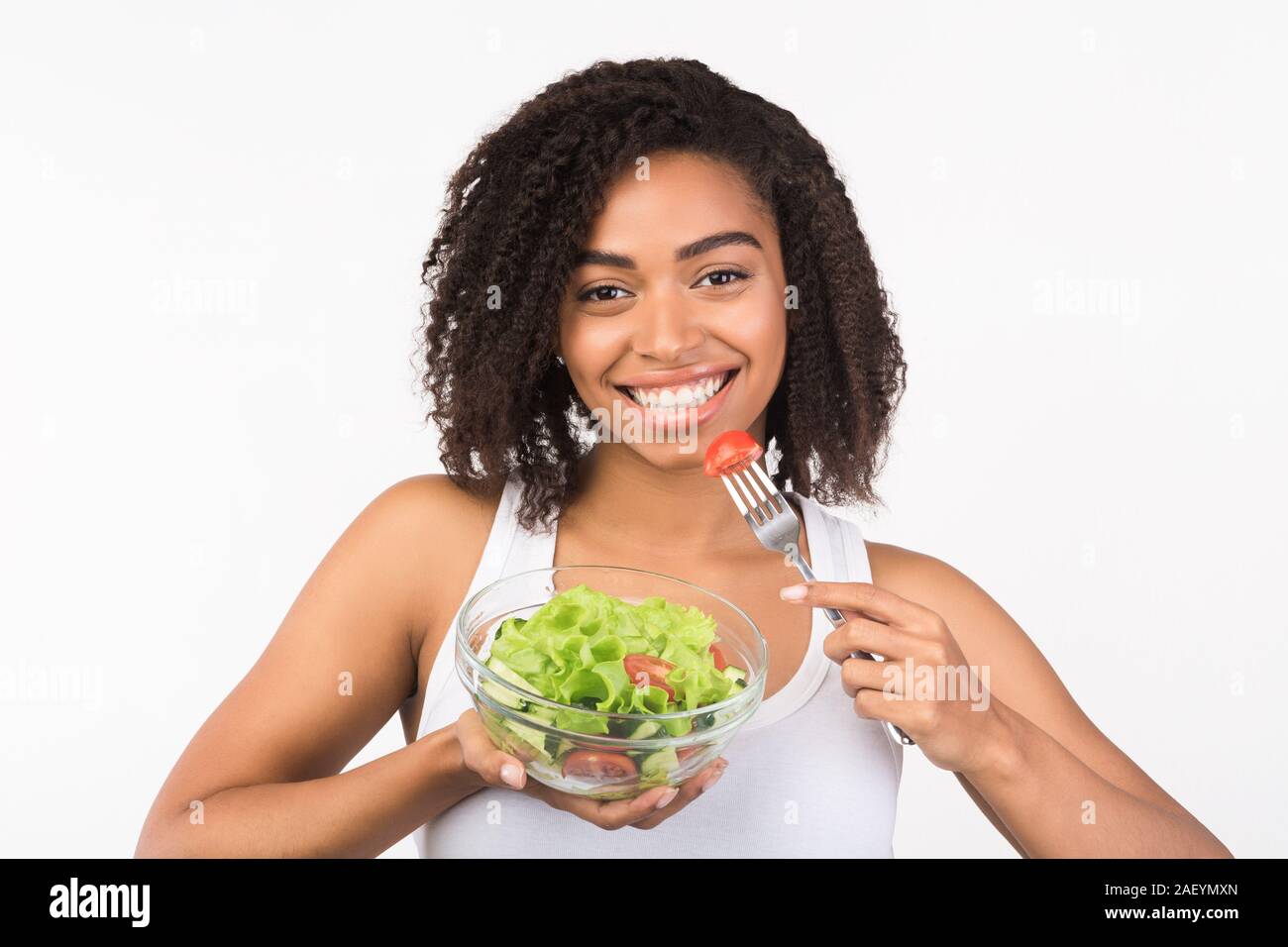 Healthy Diet. Portrait of african american woman eating salad, smiling ...