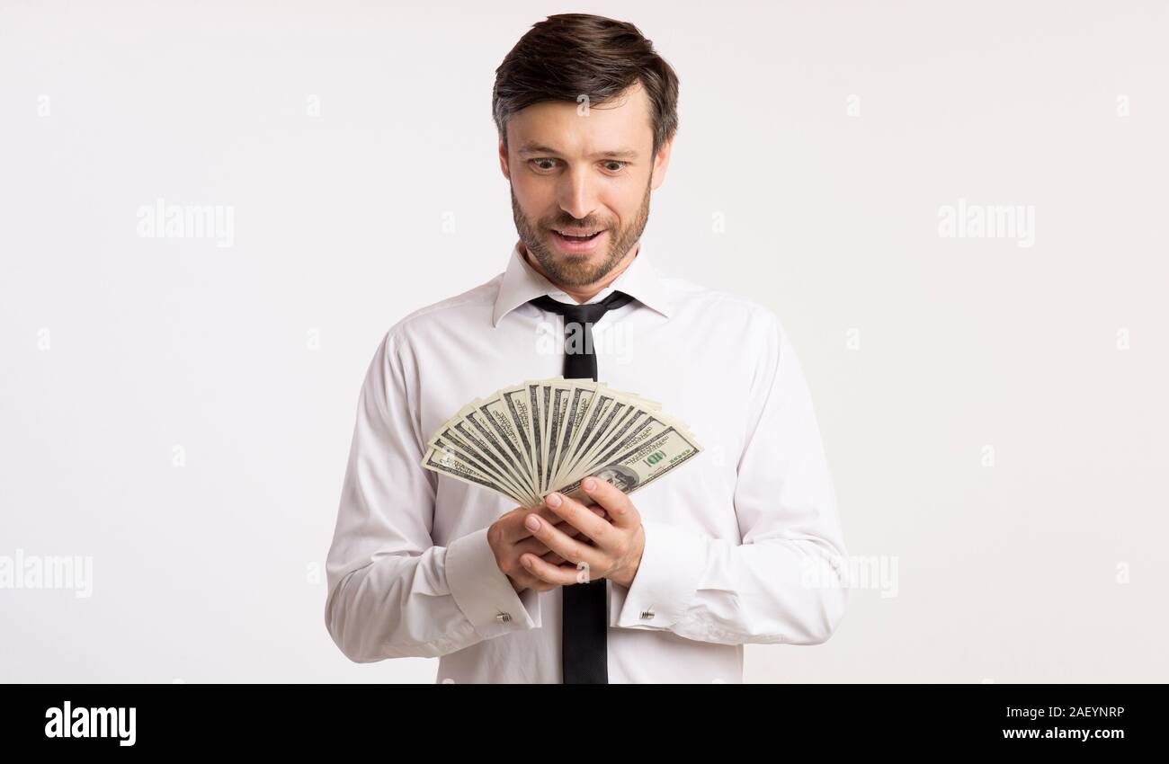 Wealth And Greed. Businessman Holding Money Cash Standing Over White ...
