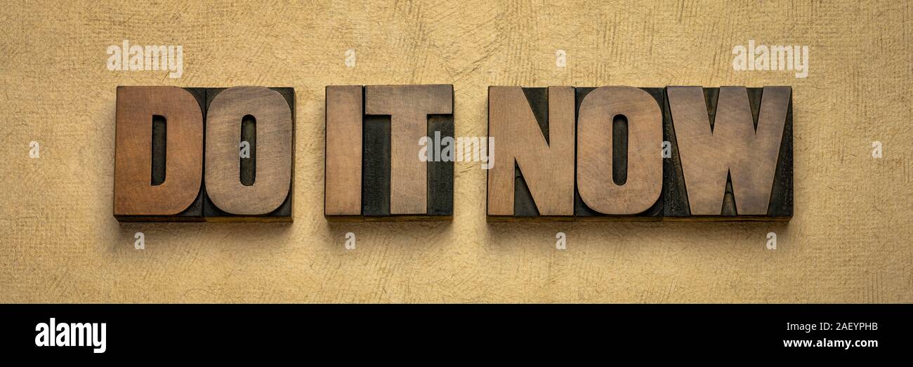 do it now - motivational word abstract in vintage letterpress wood type ...