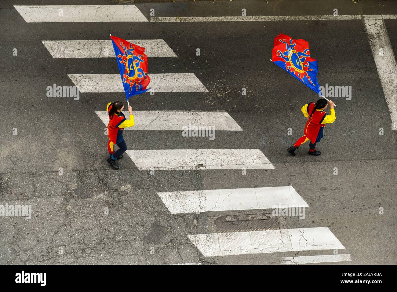Elevated view of two flag wavers in the historical parade of the famous ...