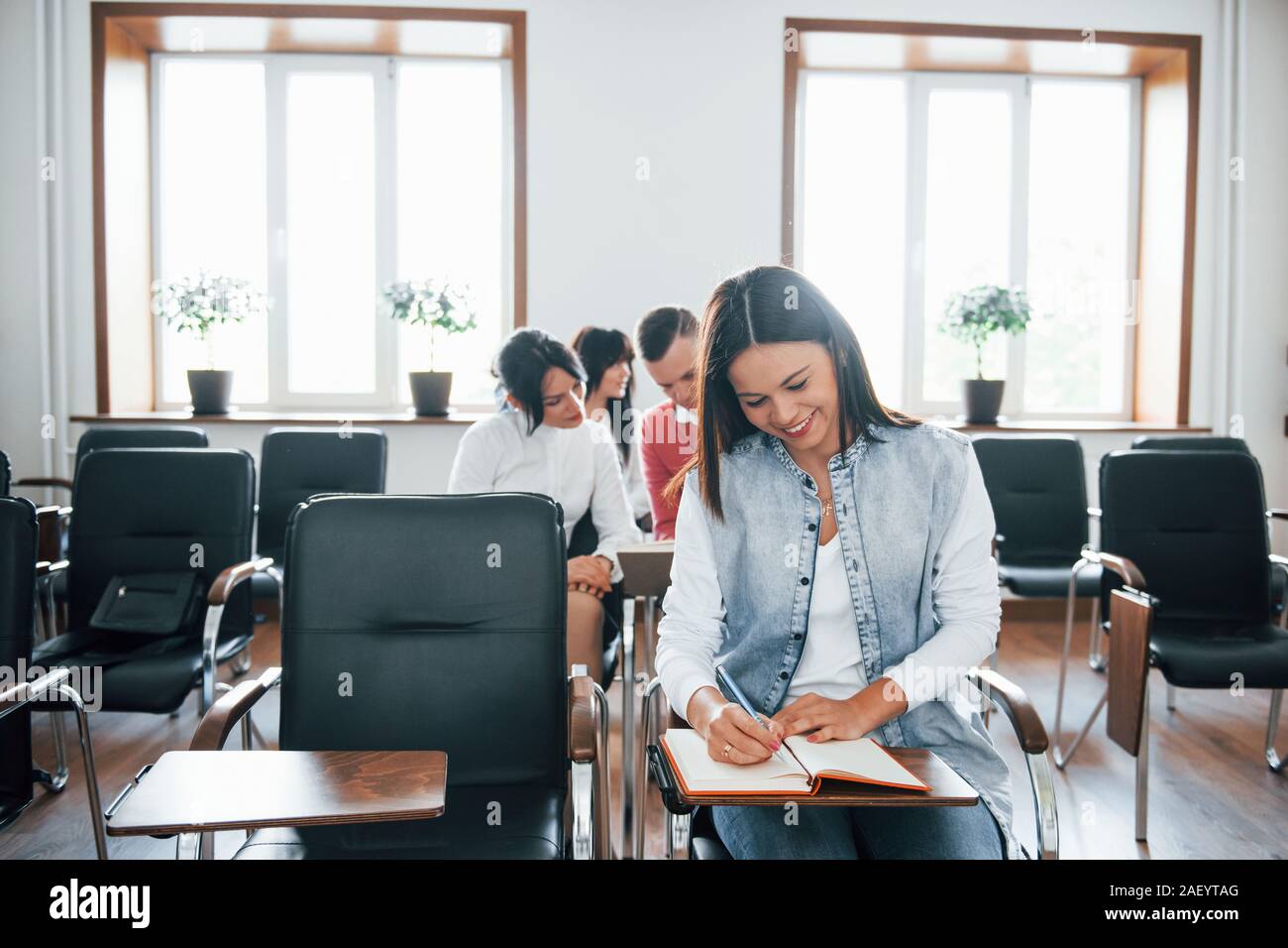 Front view. Group of people at business conference in modern classroom ...