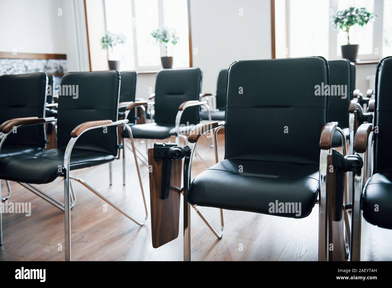 Business classroom at daytime with many of black chairs. Ready for ...