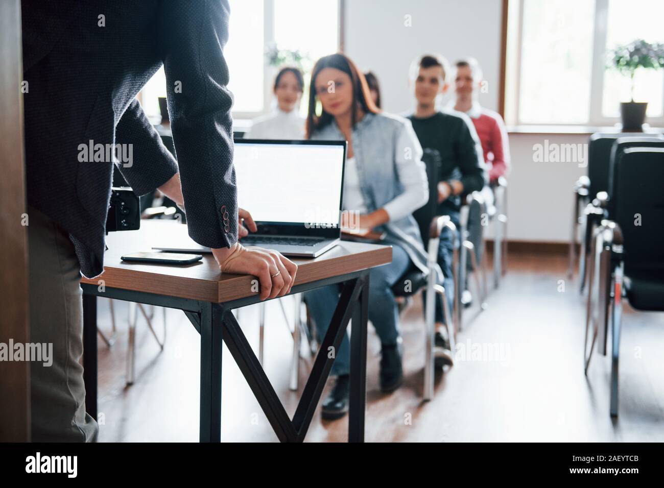 Using laptop. Group of people at business conference in modern ...