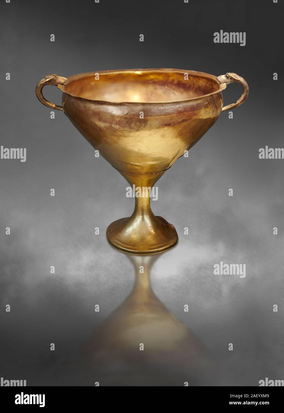 Mycenaean gold goblet with two handles ening with a dogs head biting ...