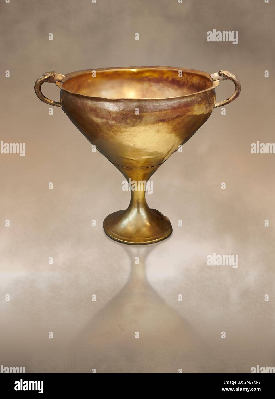 Mycenaean gold goblet with two handles ening with a dogs head biting ...