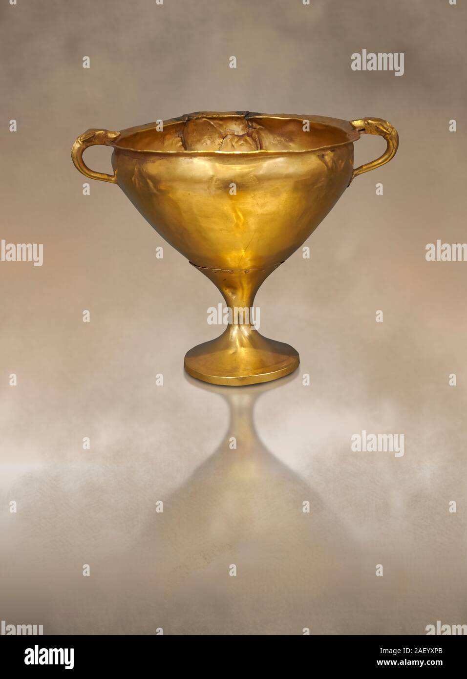 Mycenaean gold goblet with two handles ening with a dogs head biting ...
