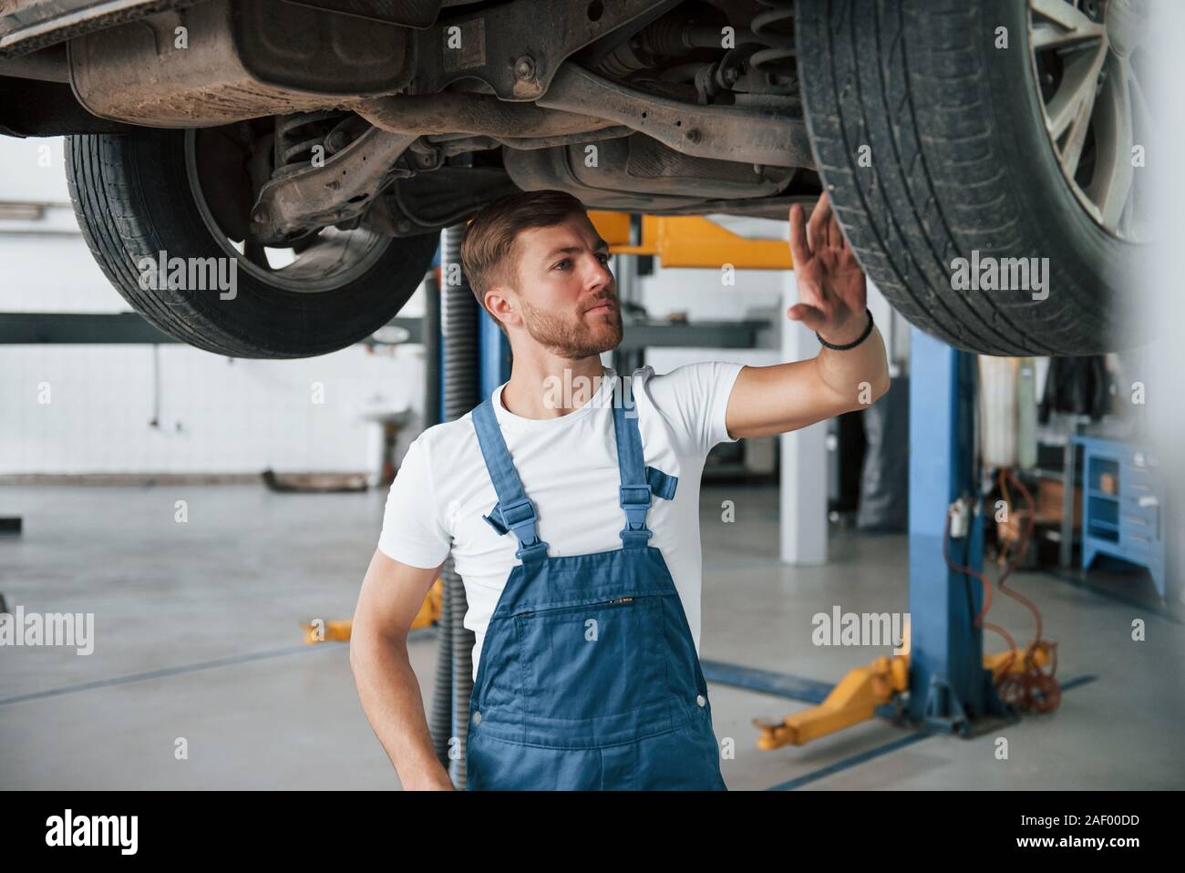 Broken transmission. Employee in the blue colored uniform works in the ...