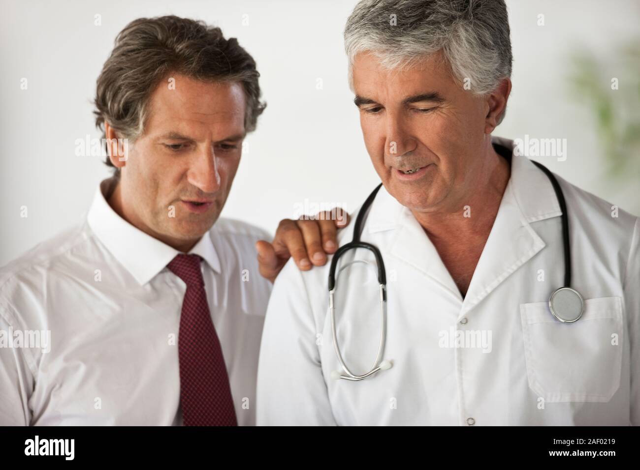 Two doctors serious conversation hi-res stock photography and images ...