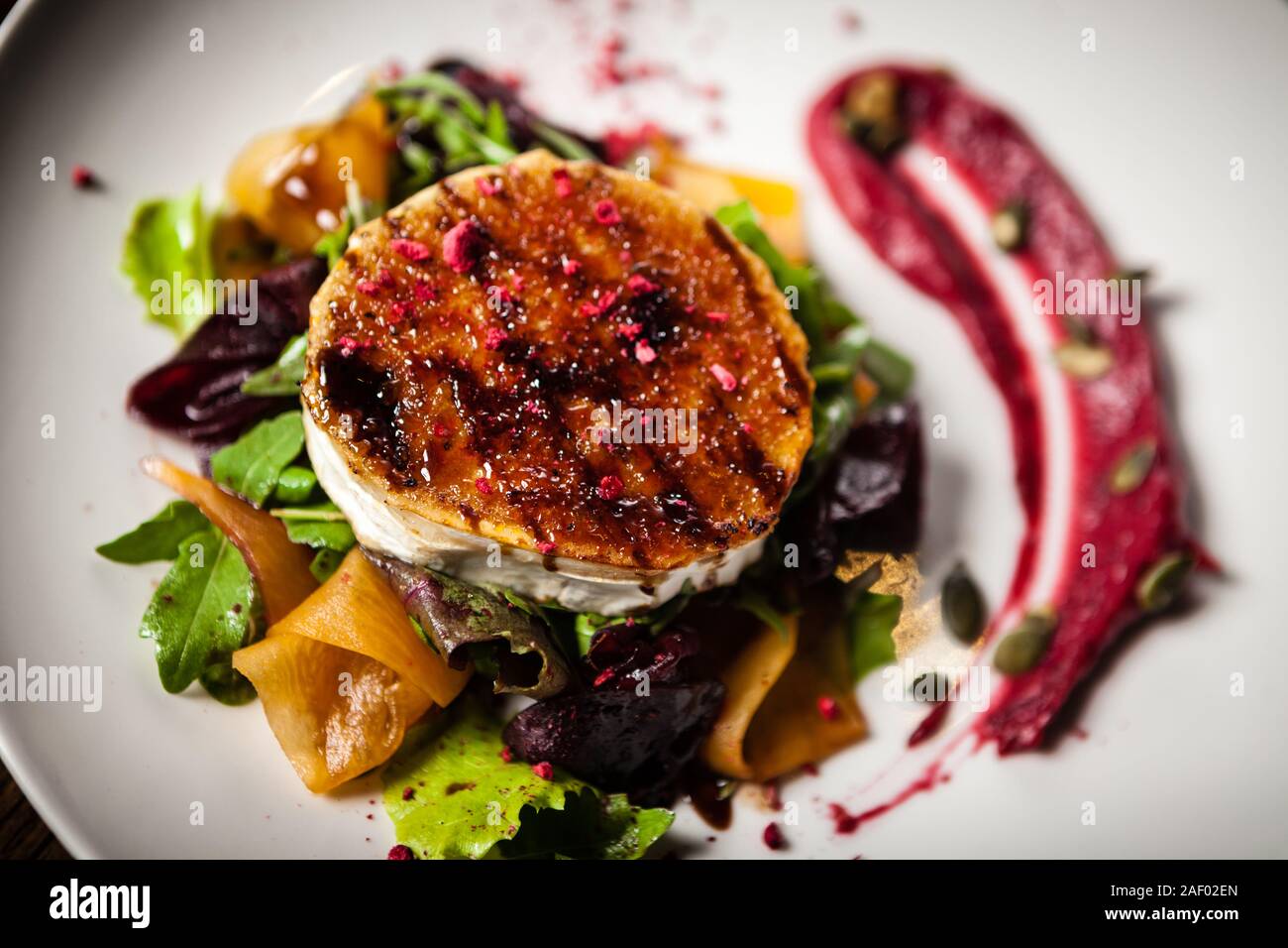 Grilled goat cheese salad served on a plate in restaurant Stock Photo ...