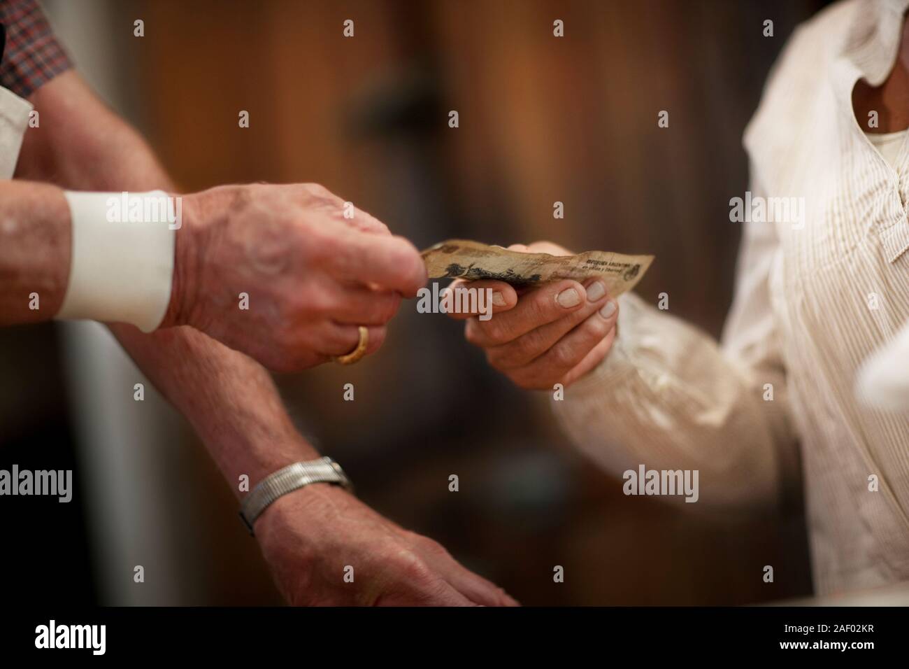Two people exchanging money Stock Photo - Alamy