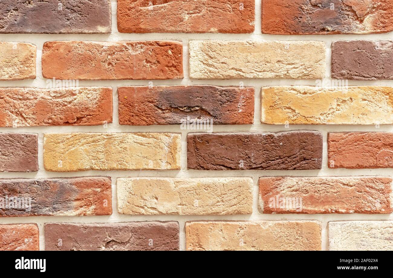 Brick wall of multicolored bricks. Background and texture of brickwork ...