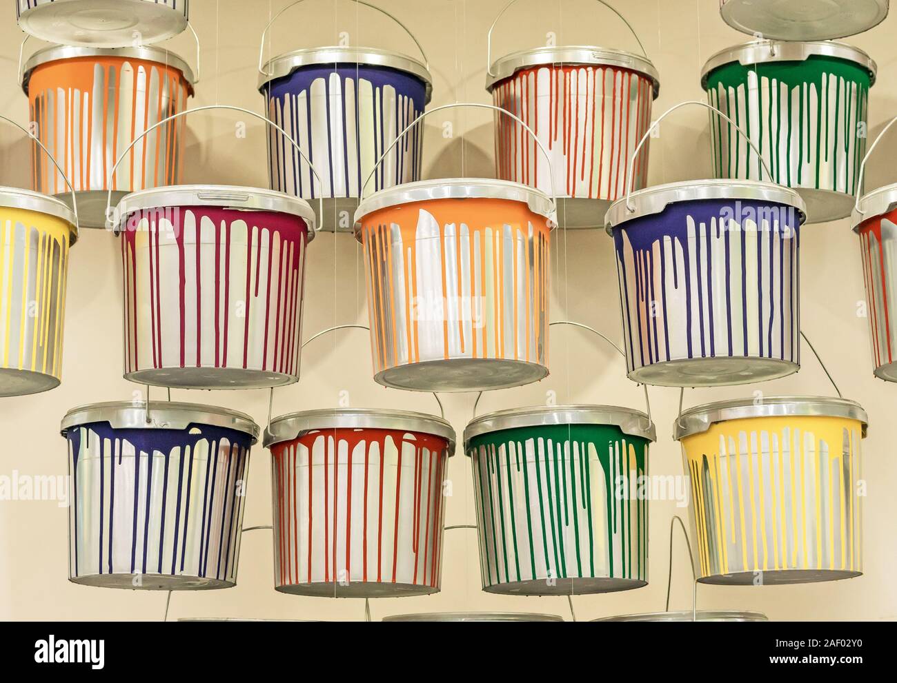 Cans with multicolored drips from a paint. Drops and spills on buckets ...