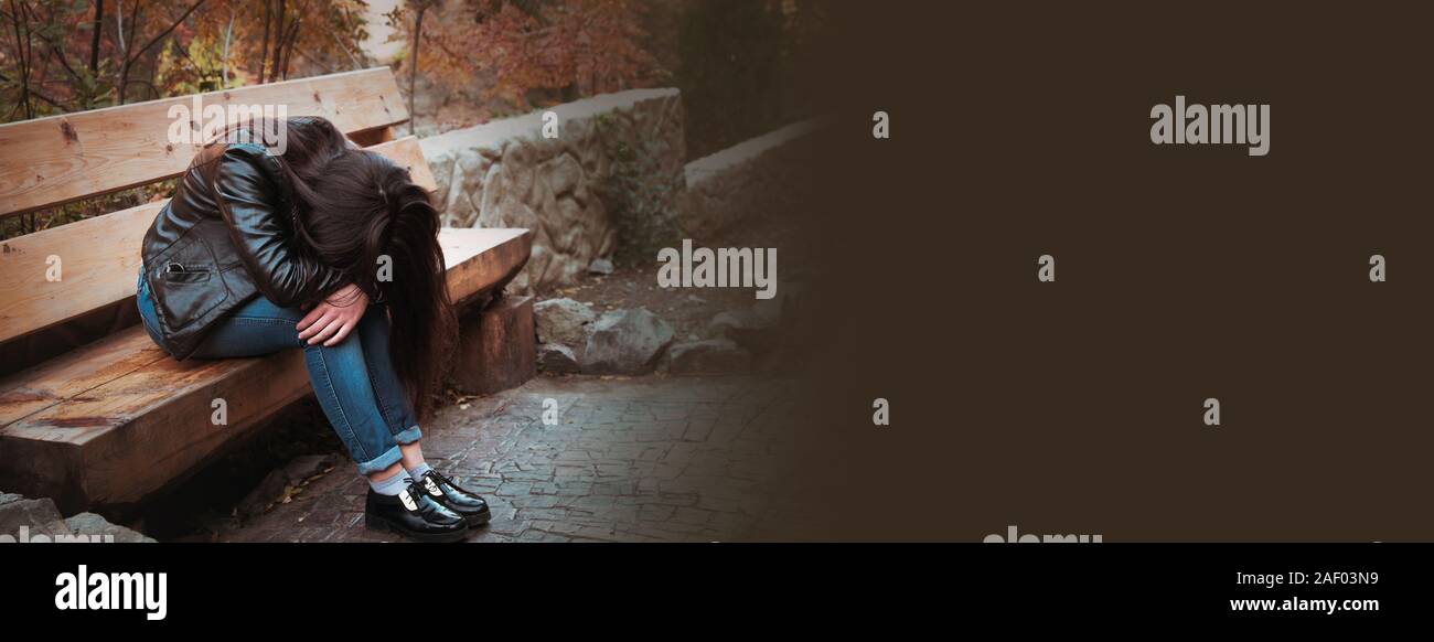 Girl in depression sitting on bench with copy space Stock Photo - Alamy