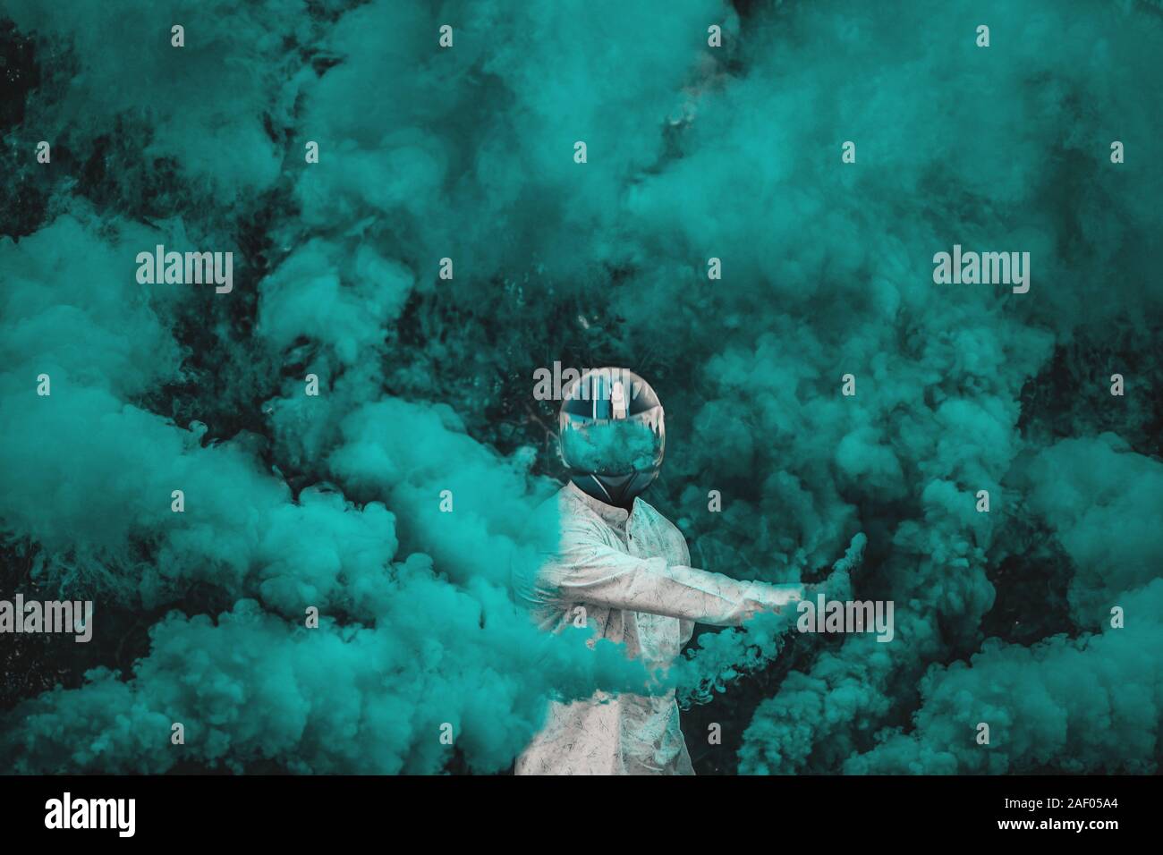 guy in mask standing in between blue smoke bombs Stock Photo - Alamy