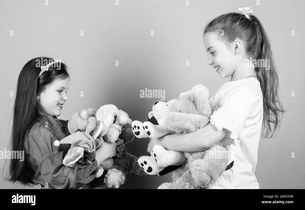 toy shop. childrens day. small girls with soft bear toys. happy ...