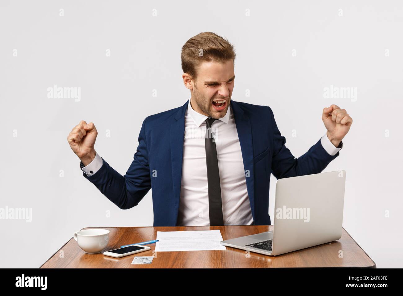 Relish, success and celebration concept. Cheerful good-looking boss ...